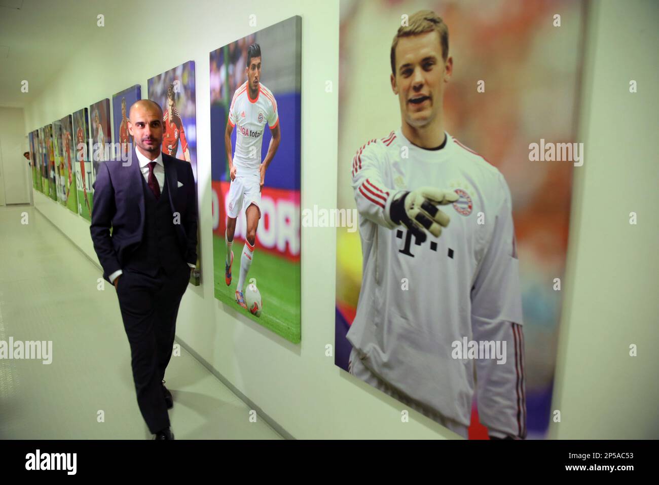 New FC Bayern Muenchen Head Coach Pep Guardiola walks past pictures of ...