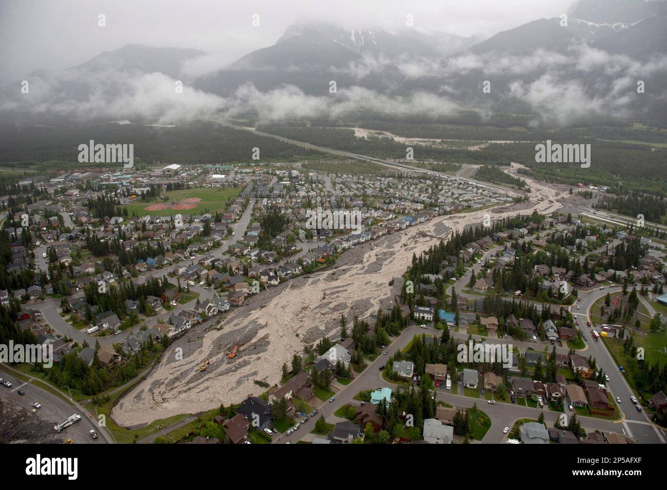 This aerial photo shows Cougar Creek running through Canmore, Alberta ...