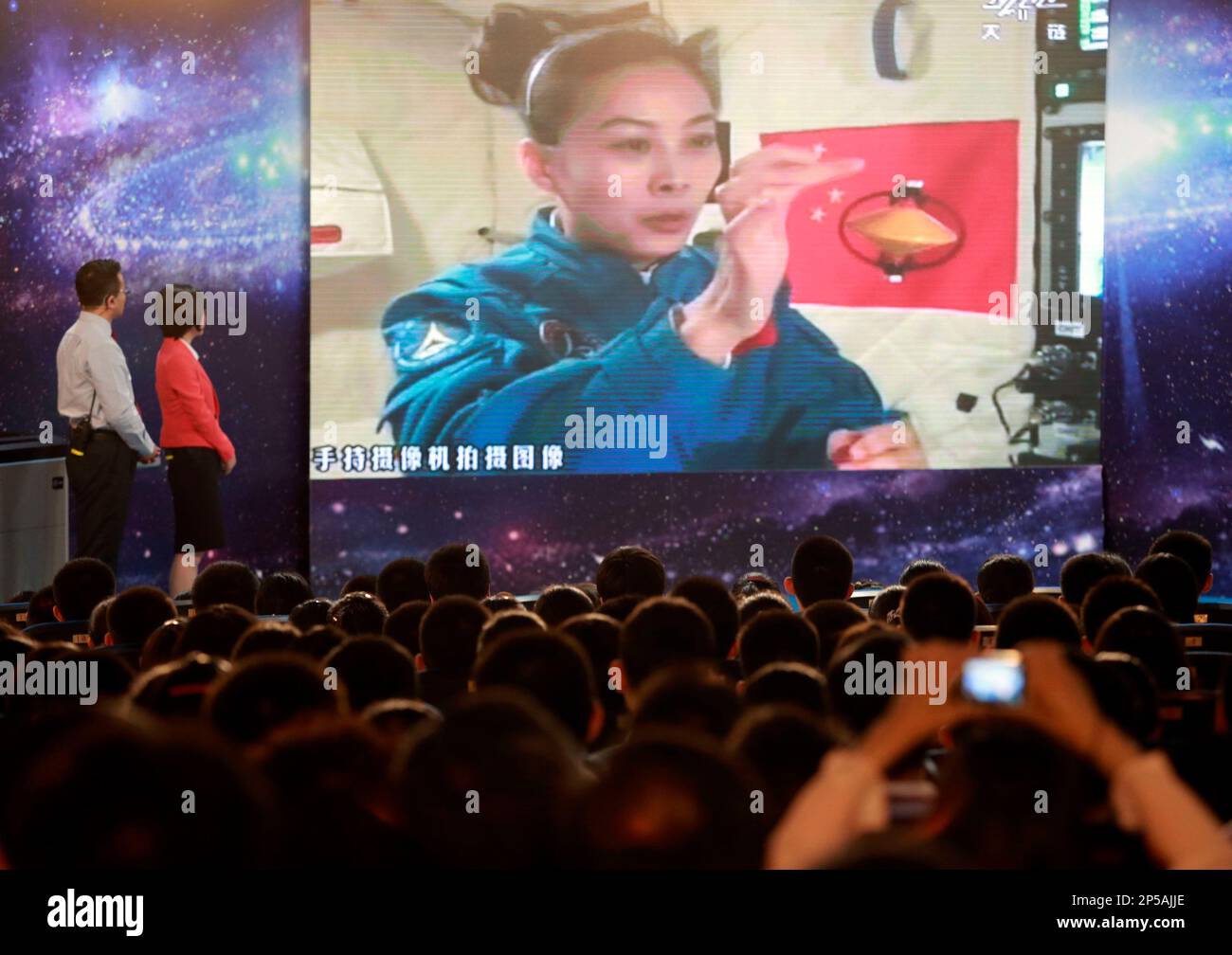 Students listen to a lecture delivered by Shenzhou-10 spacecraft female ...