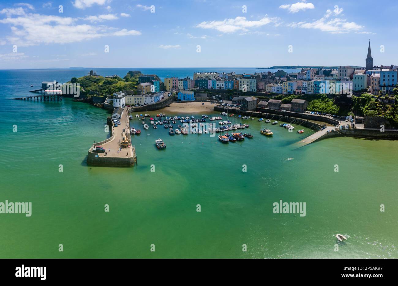 Aerial view of brightly colored buildings around a small harbour (Tenby ...