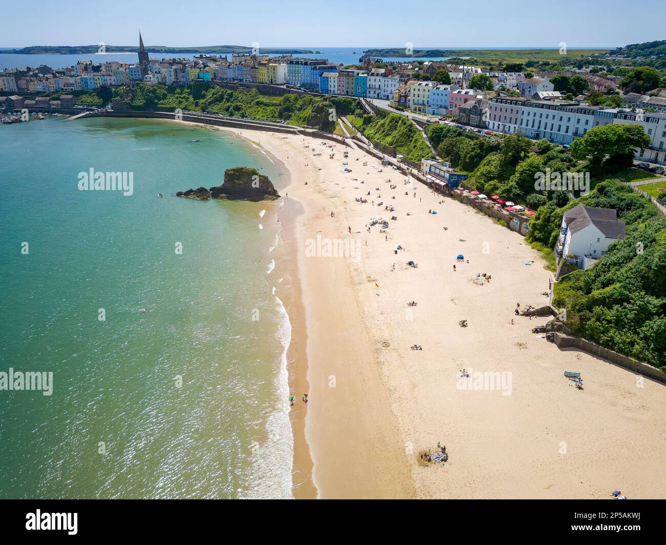Aerial view of a large sandy beach and colorful buildings behind (Tenby ...