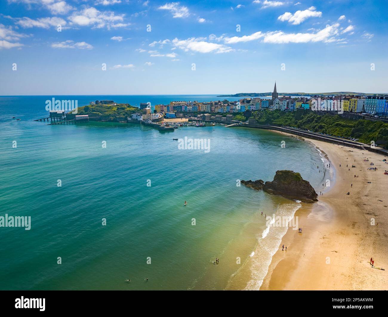 Aerial view of a large sandy beach and colorful buildings behind (Tenby ...