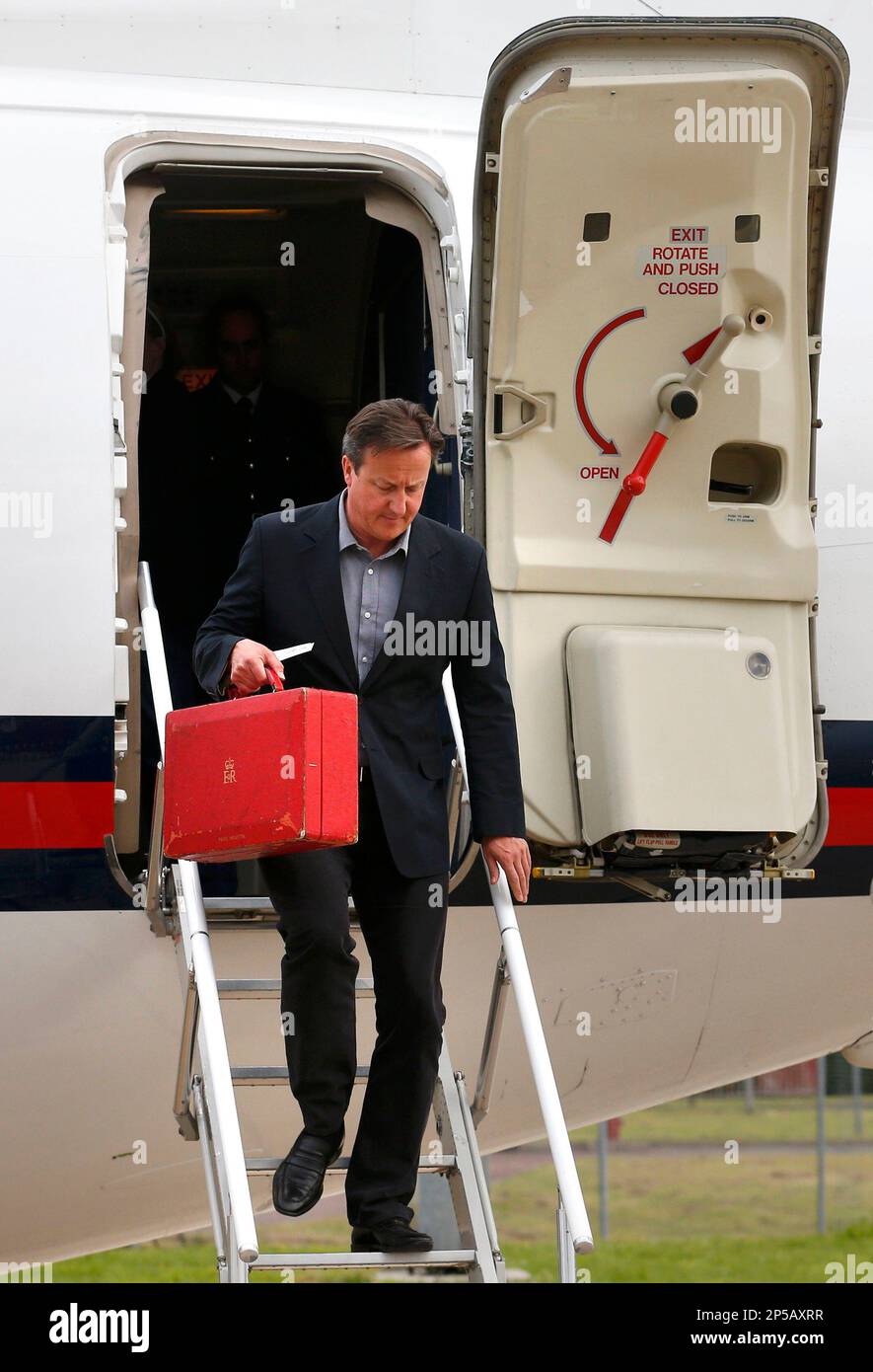 Britain's Prime Minister David Cameron steps off of his plane as he ...