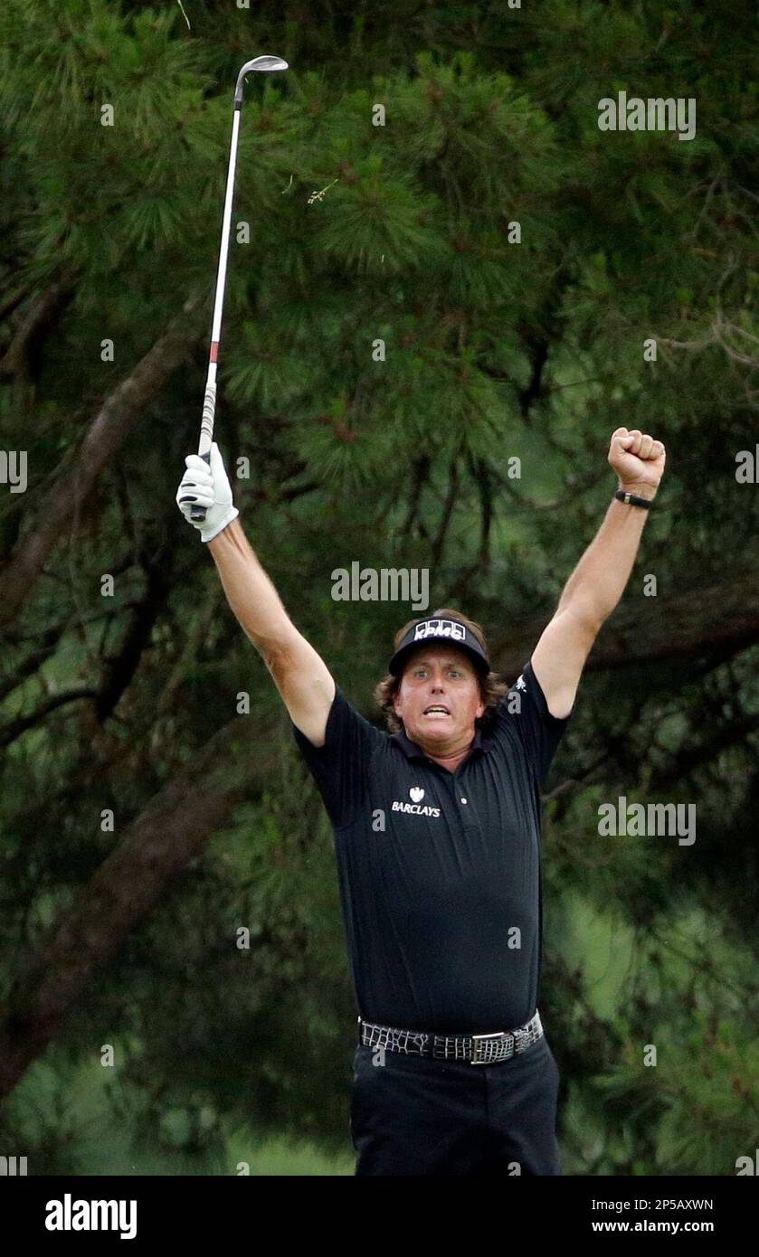 Phil Mickelson reacts after hitting an eagle on the 10th hole during ...