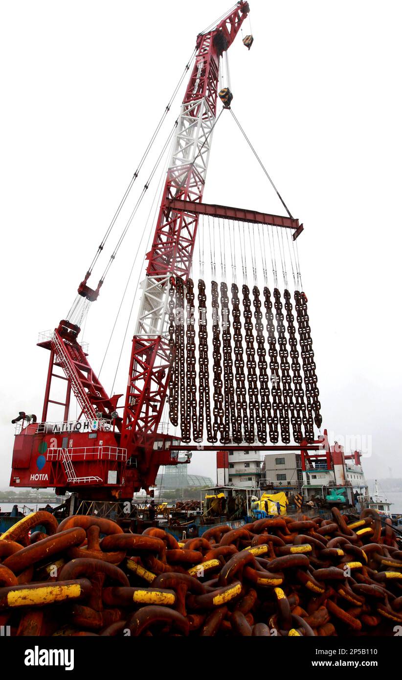 Gigantic chains are loaded onto a ship by crane at Onahama Port in ...