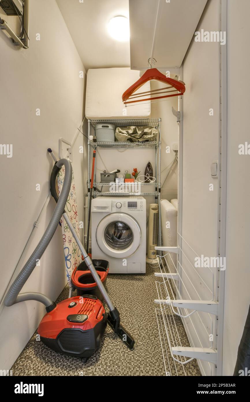 the inside of a laundry room with a vacuum and dryer on the floor in ...