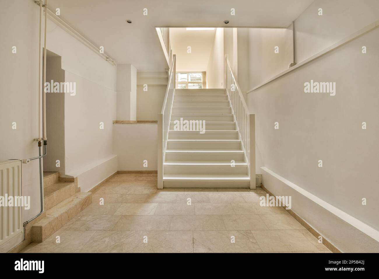 an empty room with stairs leading up to the second floor and another ...