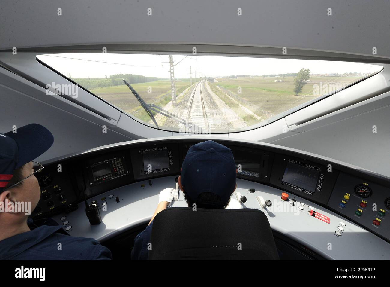 Drivers control a new CRH3A high-speed train during a launch ceremony ...