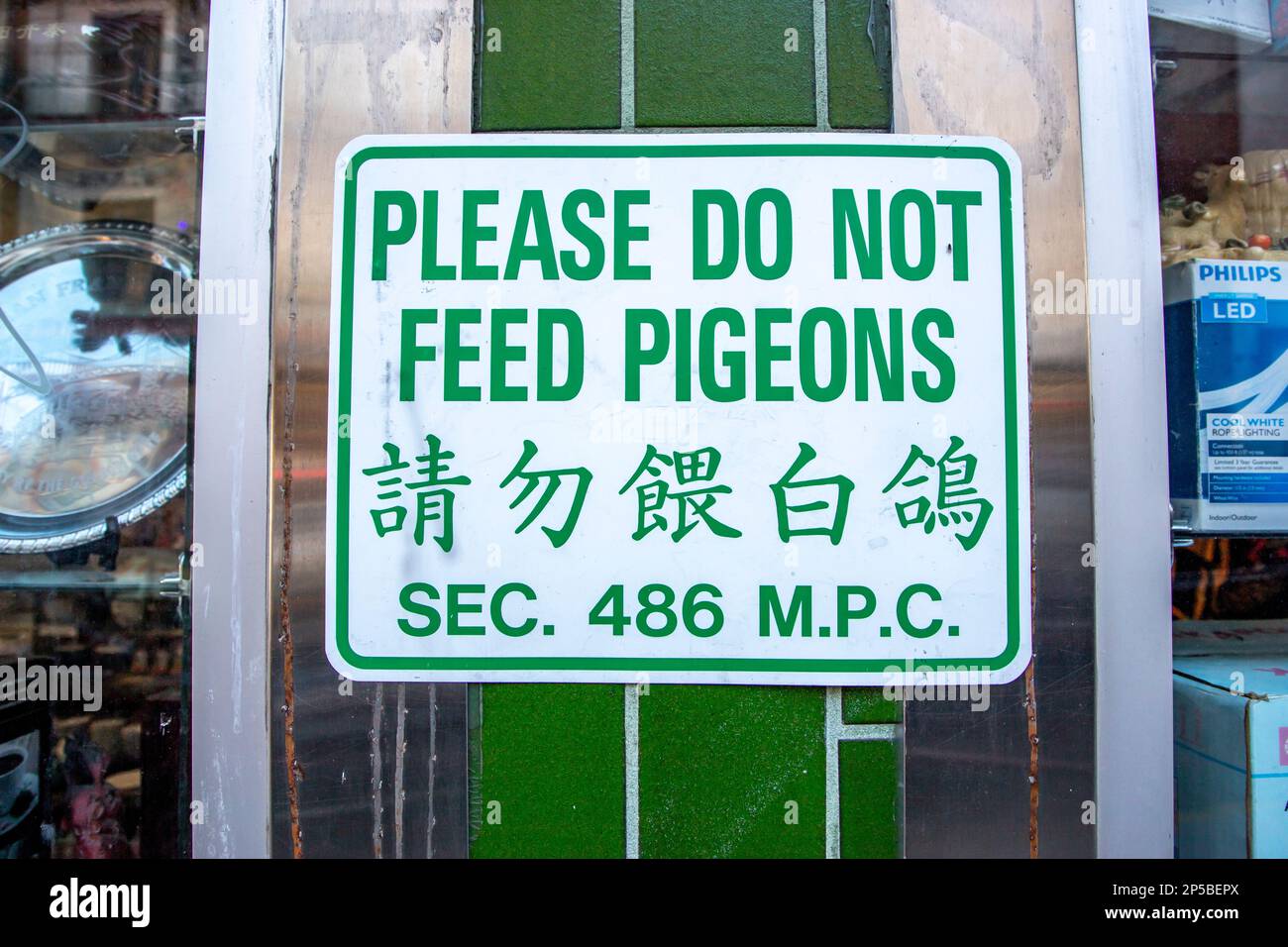 Exploring Chinatown in San Francisco, California. A sign saying "Please ...
