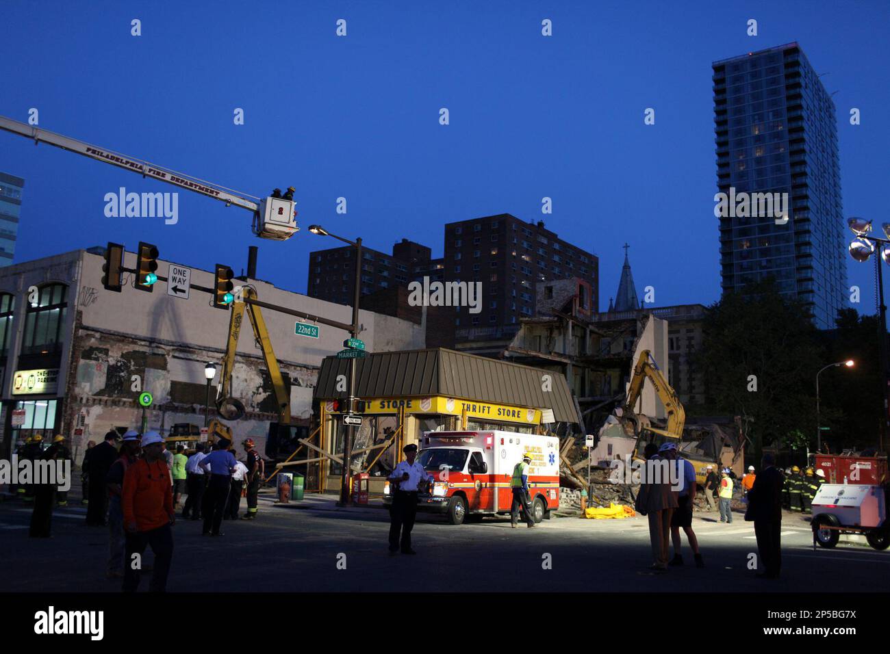 Emergency personnel work the scene of a building collapse in downtown ...