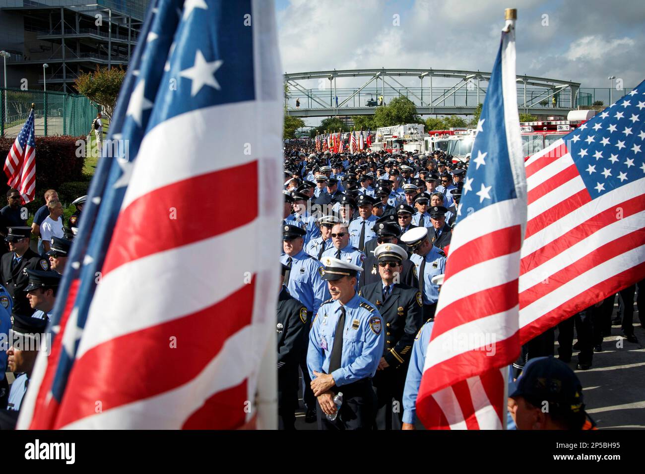 Emergency personnel take part in a memorial service honoring four Houston firefighters at ...