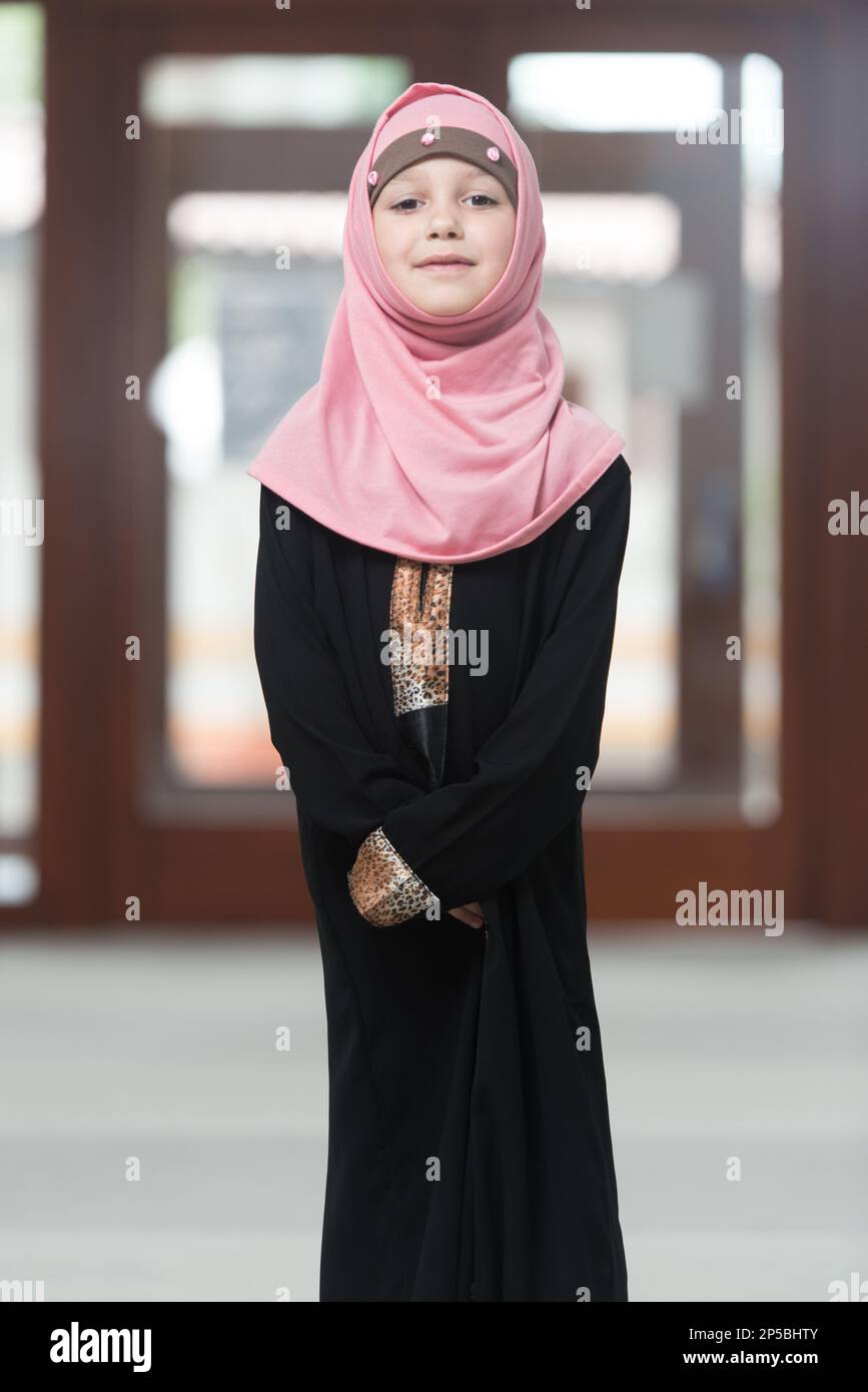 Portrait of a Young Muslim Child Is Praying In The Mosque While Wearing ...