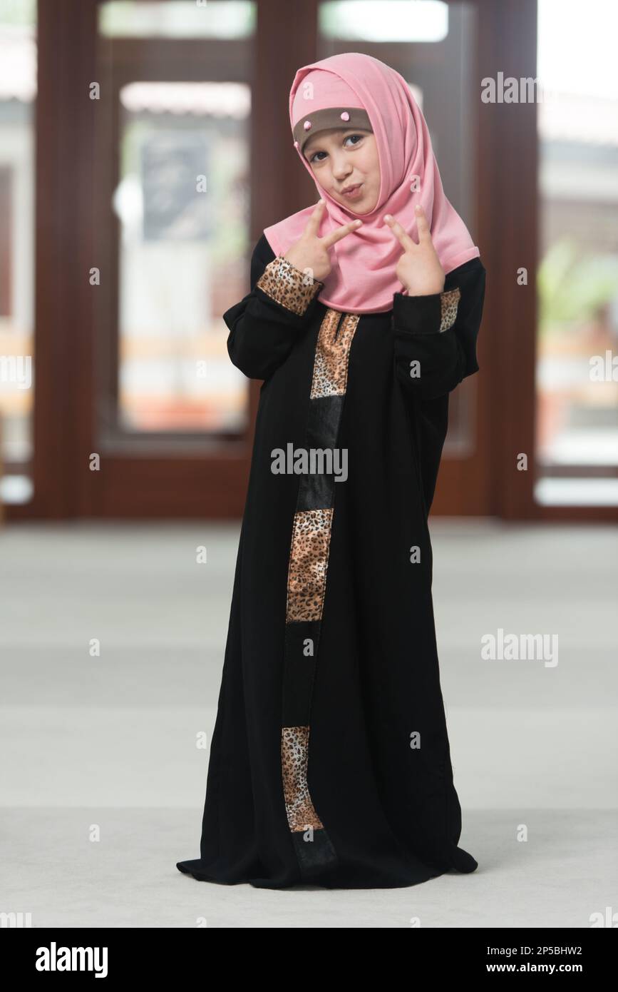 Young Muslim Girl Making Traditional Prayer To God While Wearing A ...