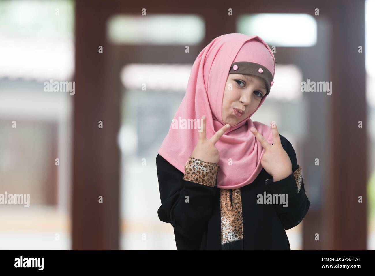 Young Muslim Girl Making Traditional Prayer To God While Wearing A ...