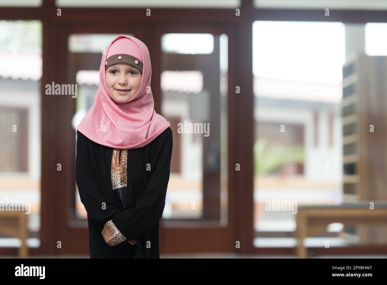 Portrait of a Young Muslim Child Is Praying In The Mosque While Wearing ...