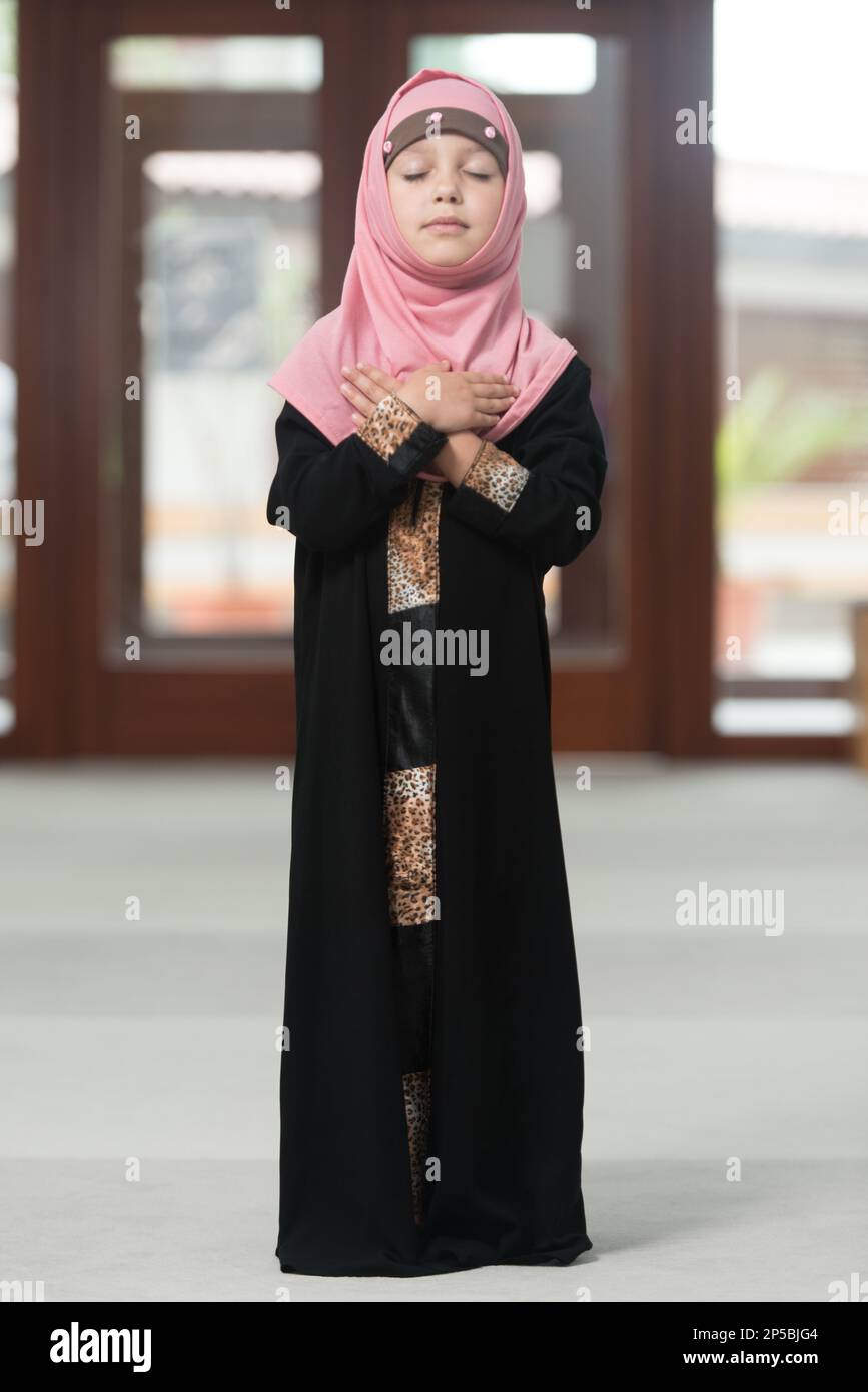 Young Muslim Girl Making Traditional Prayer To God While Wearing A ...
