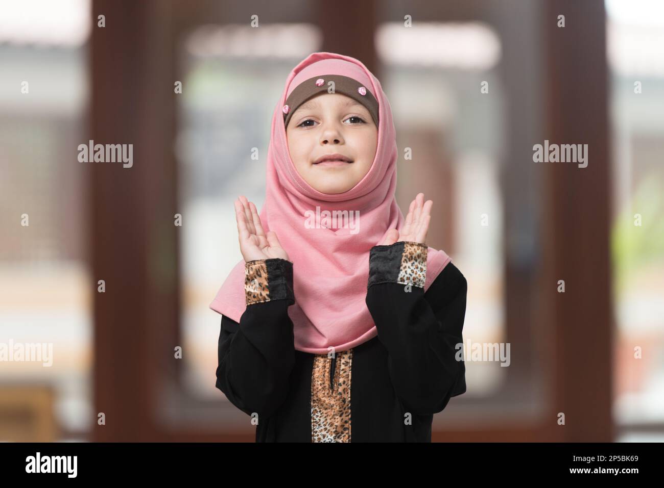 Young Muslim Girl Making Traditional Prayer To God While Wearing A ...