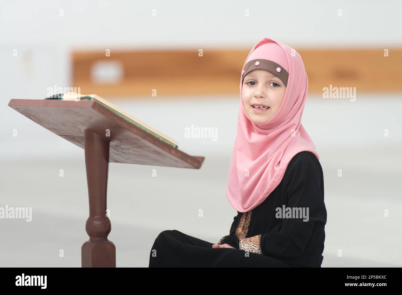 Portrait of a Muslim Young Girl Reading Holy Islamic Book Koran While ...