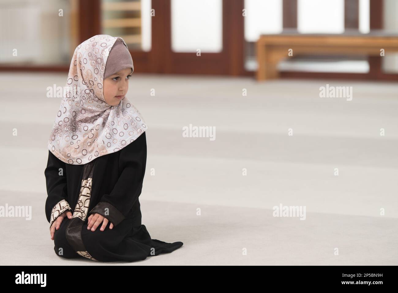 Young Muslim Girl Making Traditional Prayer To God While Wearing A ...