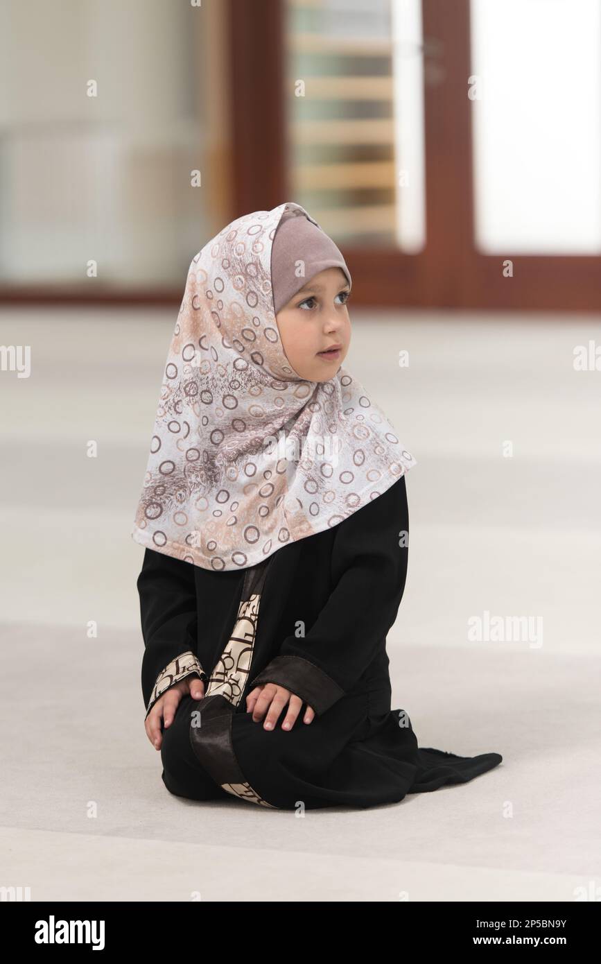 Young Muslim Girl Making Traditional Prayer To God While Wearing A ...