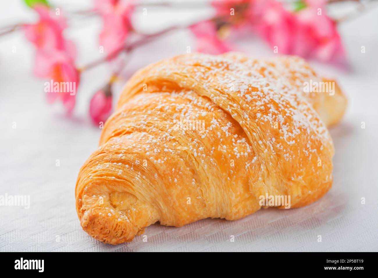 Croissant with sugar candy, typical morning breakfast. White background ...