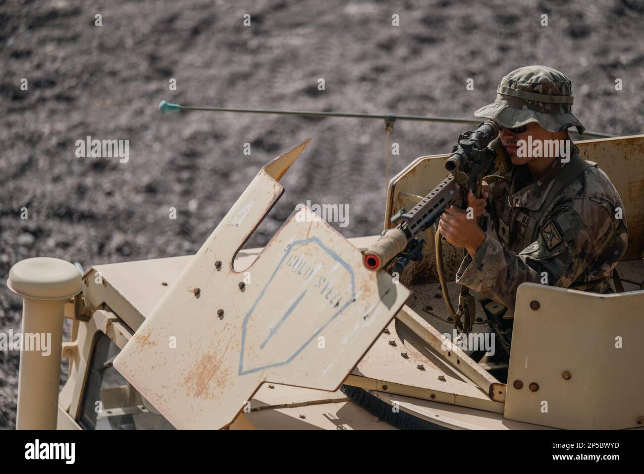 A U.S. Army soldier assigned to Task Force Wolfhound aims a weapon at ...