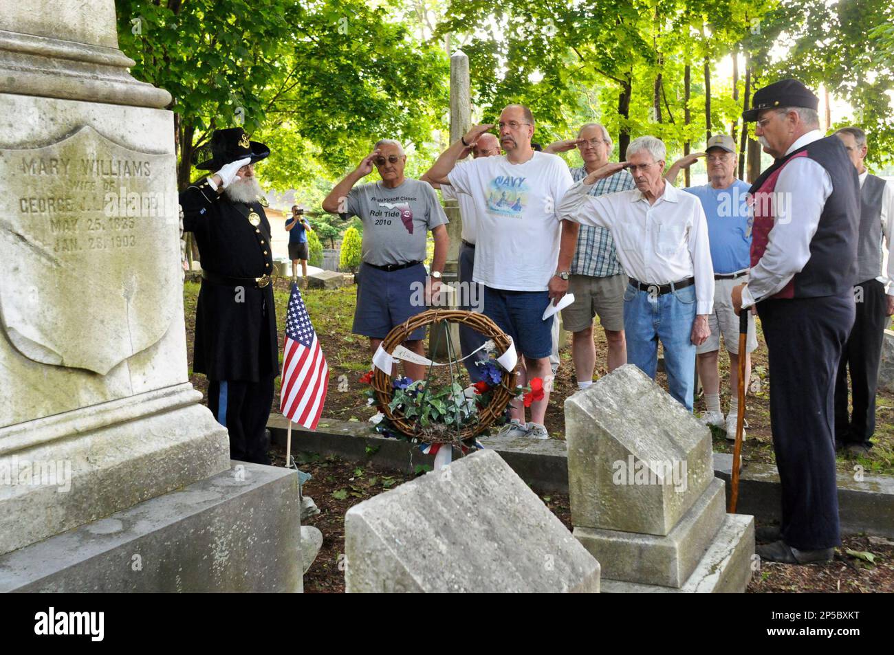 Saluting at the grave of Capt. George J. Lawrence after the placing of ...