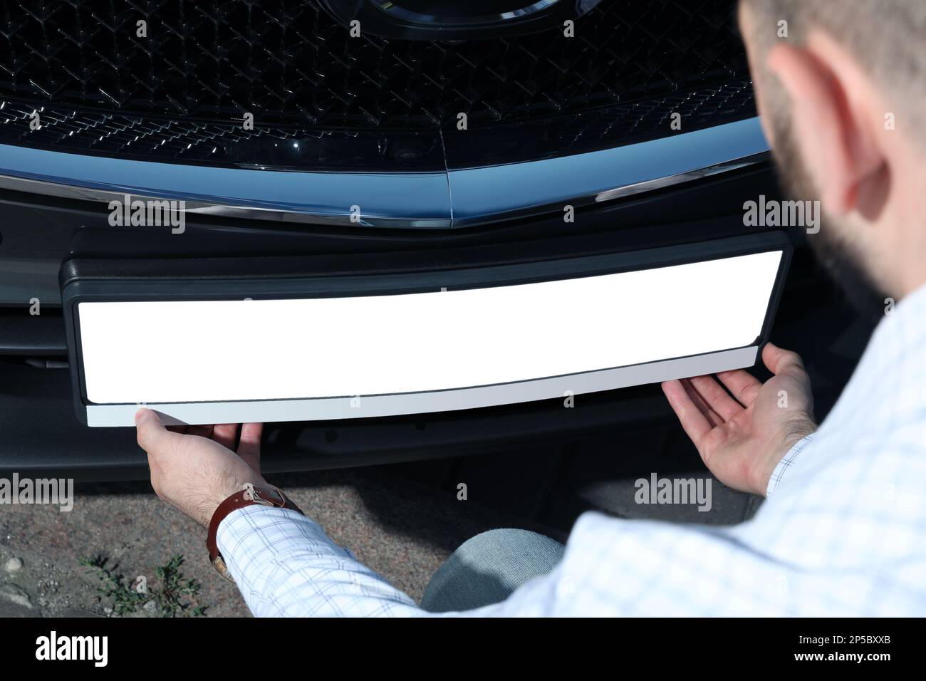 Man installing vehicle registration plate outdoors, closeup Stock Photo ...