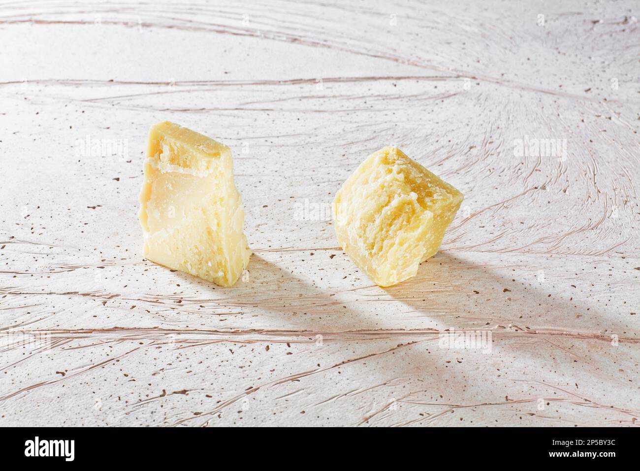 Slice of Parmigiano Reggiano, an Italian grated cheese on a marble base ...