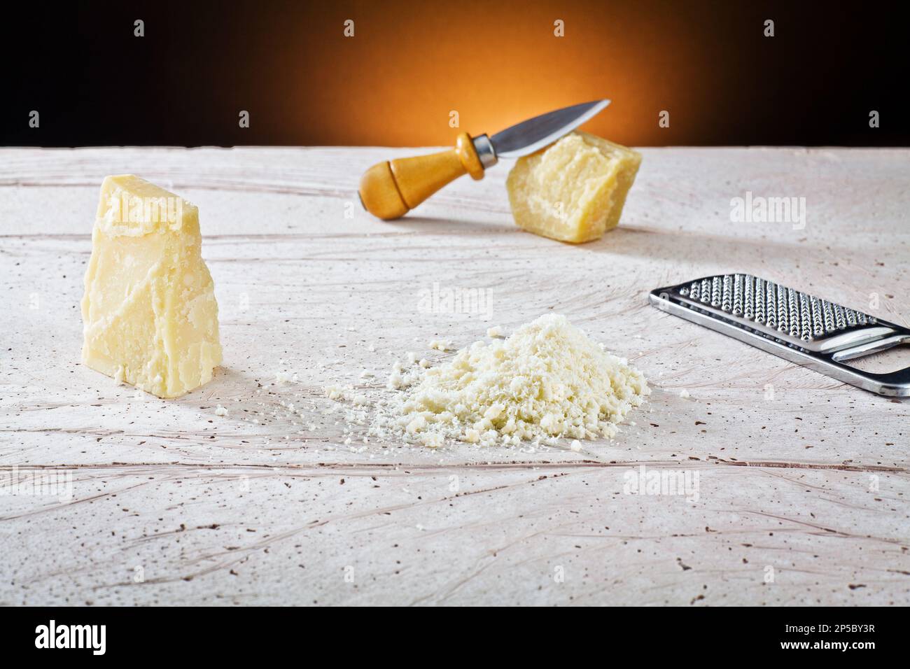 Slice of Parmigiano Reggiano, an Italian grated cheese on a marble base ...