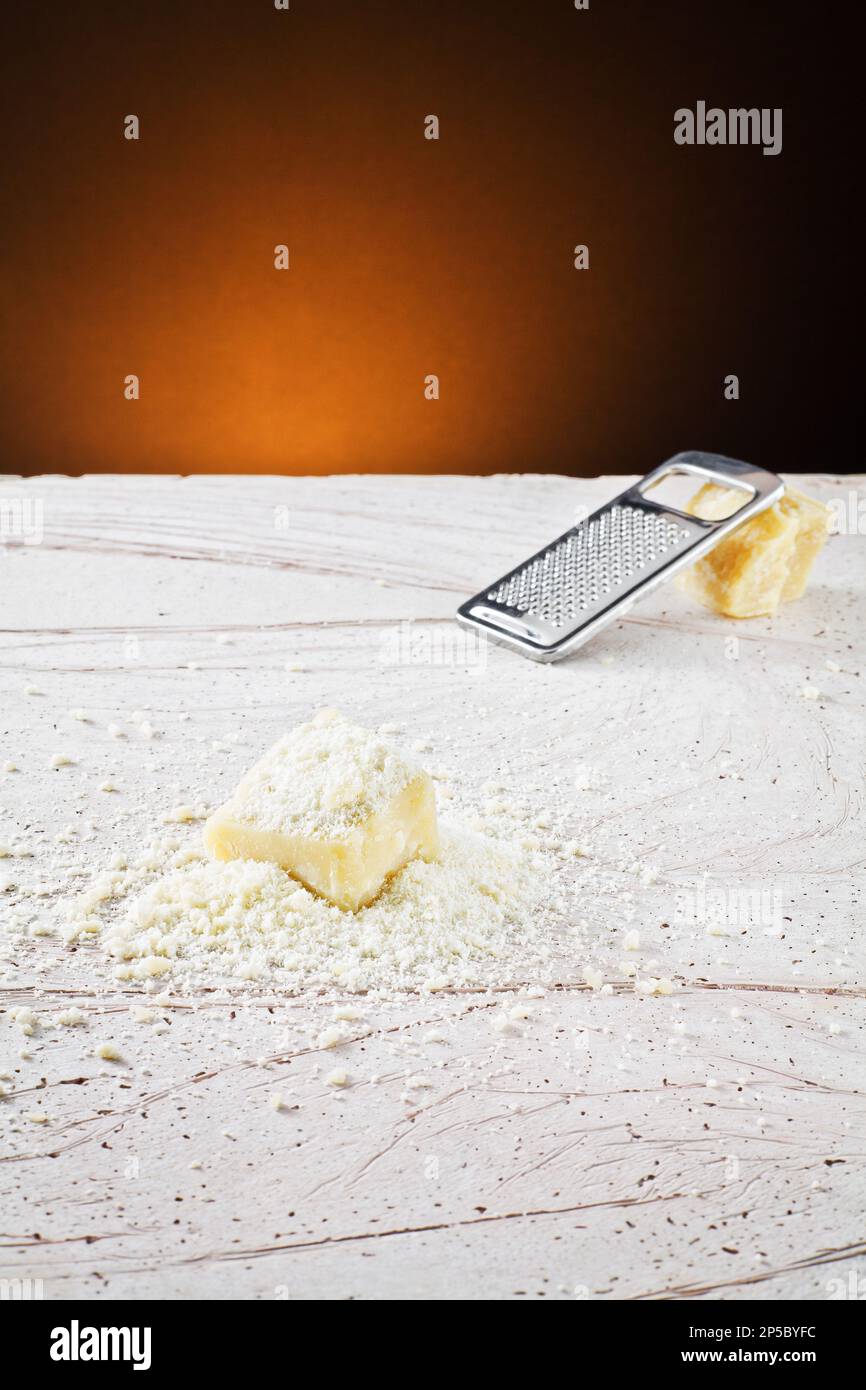 Slice of Parmigiano Reggiano, an Italian grated cheese on a marble base ...