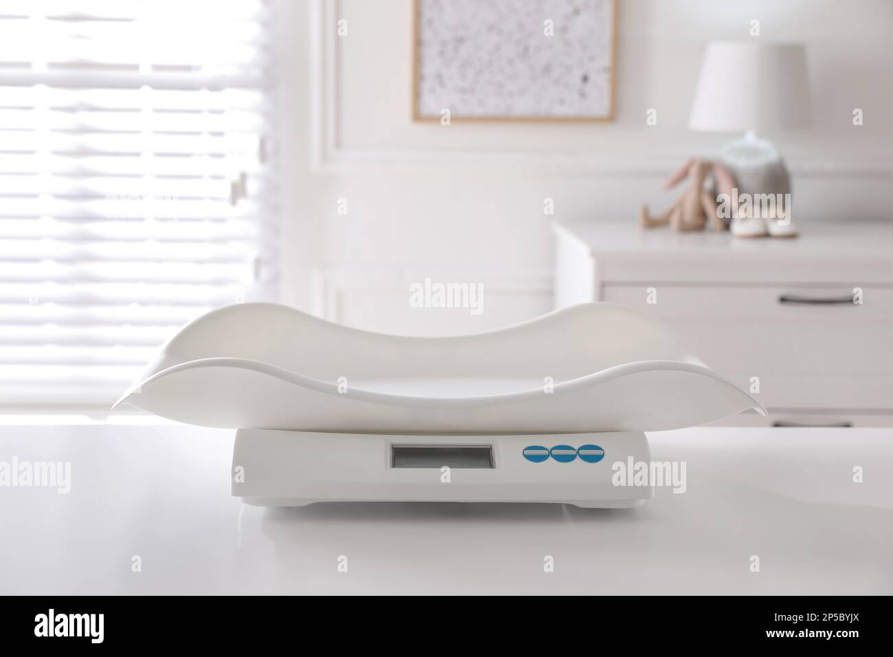Modern digital baby scales on table in room Stock Photo - Alamy