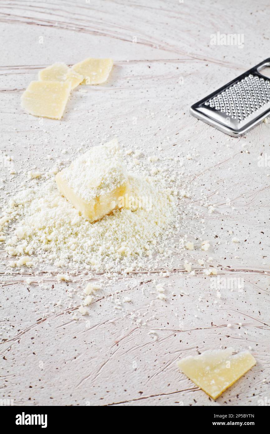 Slice of Parmigiano Reggiano, an Italian grated cheese on a marble base ...