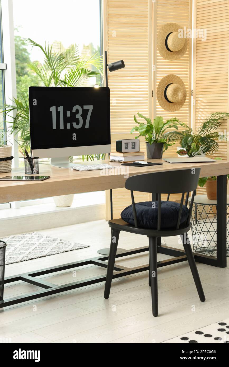 Comfortable workplace with computer in light room. Interior design ...