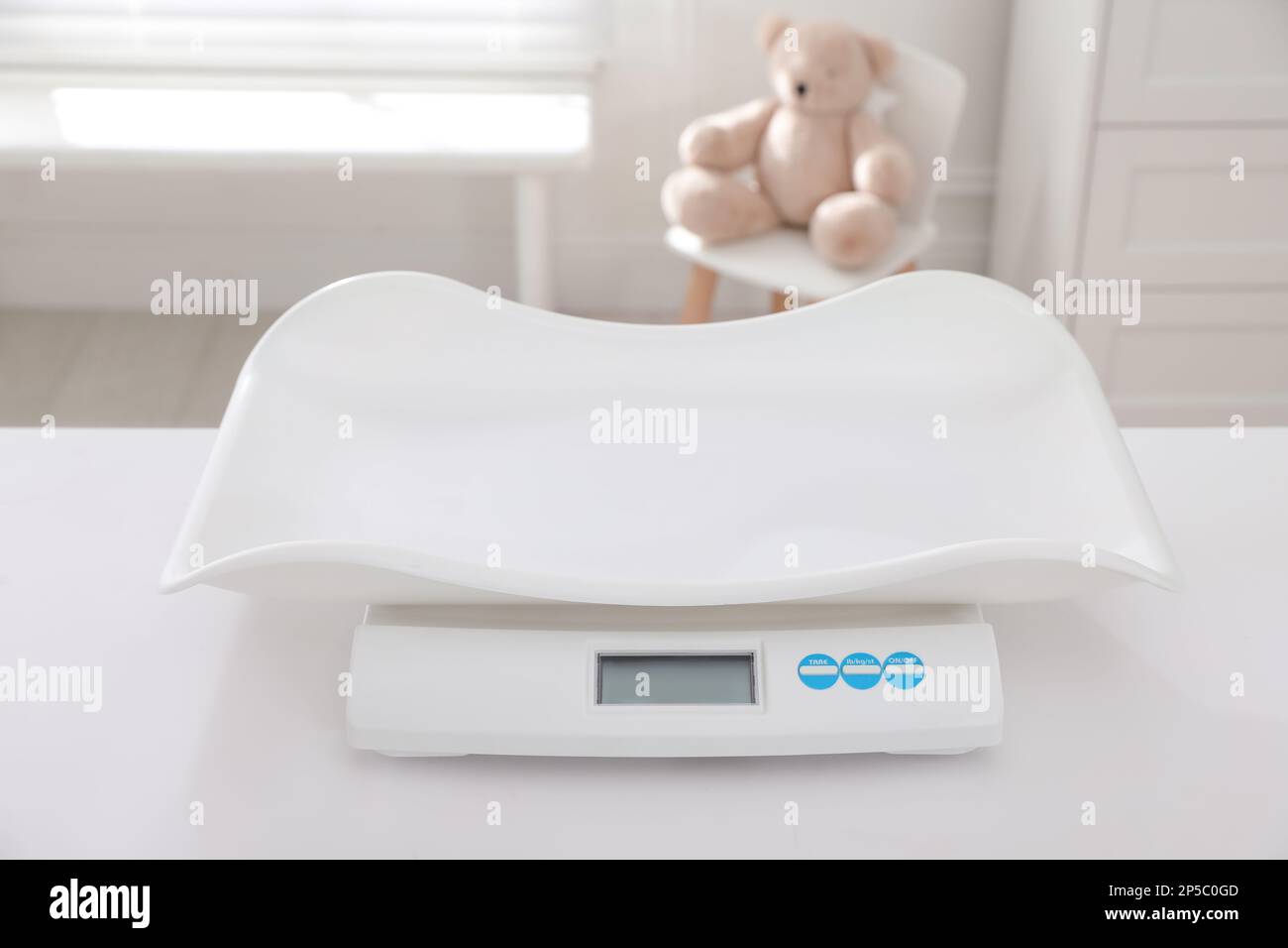 Modern digital baby scales on table in room Stock Photo - Alamy
