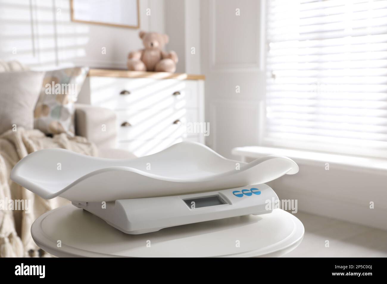 Modern digital baby scales on table in room Stock Photo - Alamy