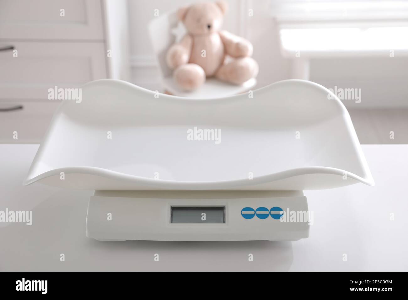 Modern digital baby scales on table in room Stock Photo - Alamy