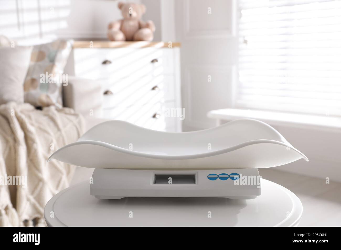 Modern digital baby scales on table in room Stock Photo - Alamy