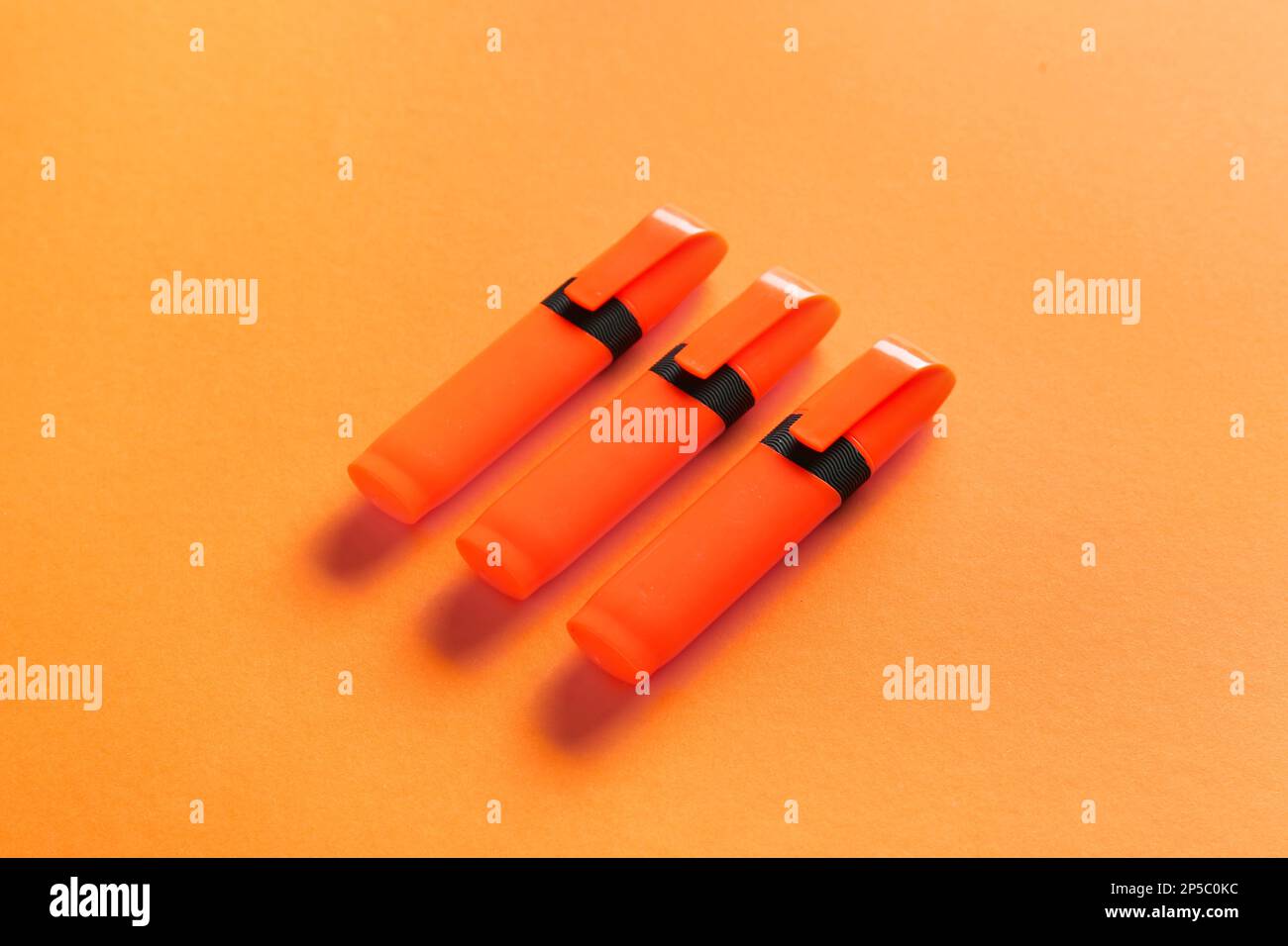 Permanent markers on orange background Stock Photo - Alamy