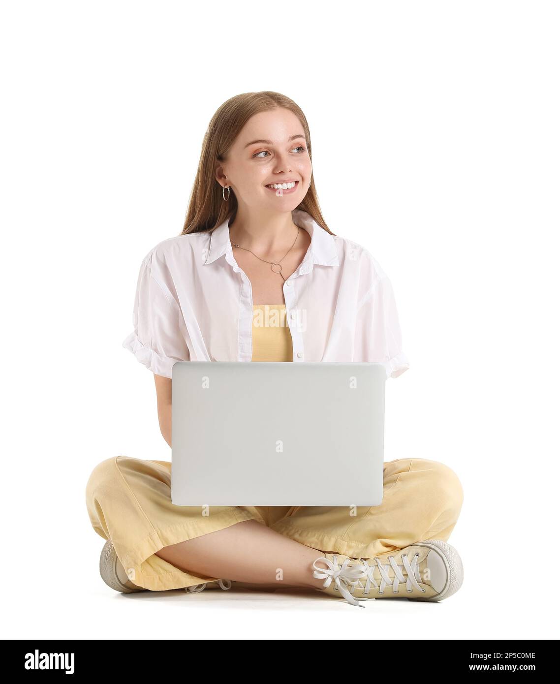 Beautiful girl with laptop sitting on white background Stock Photo - Alamy