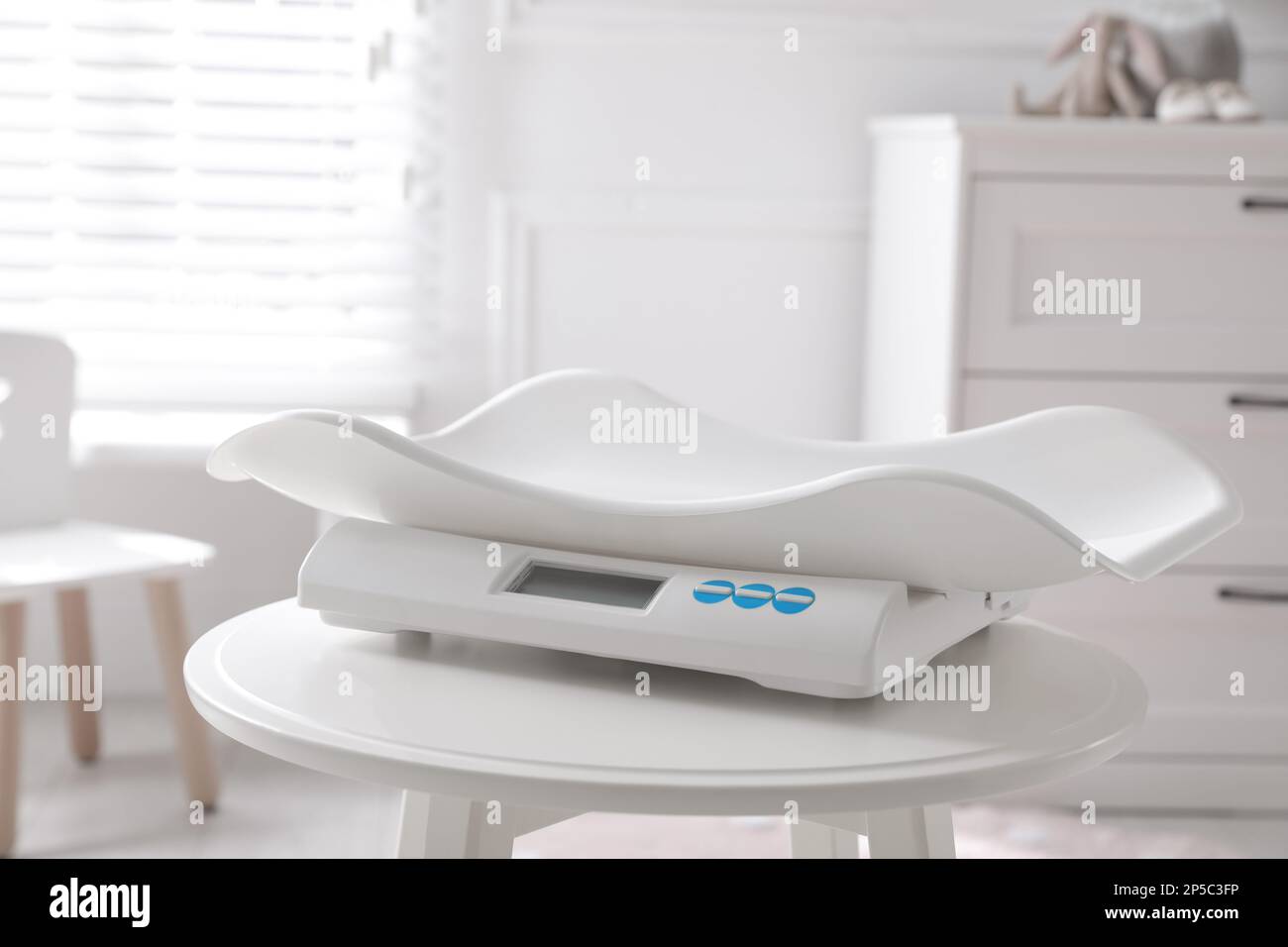 Modern digital baby scales on table in room Stock Photo - Alamy