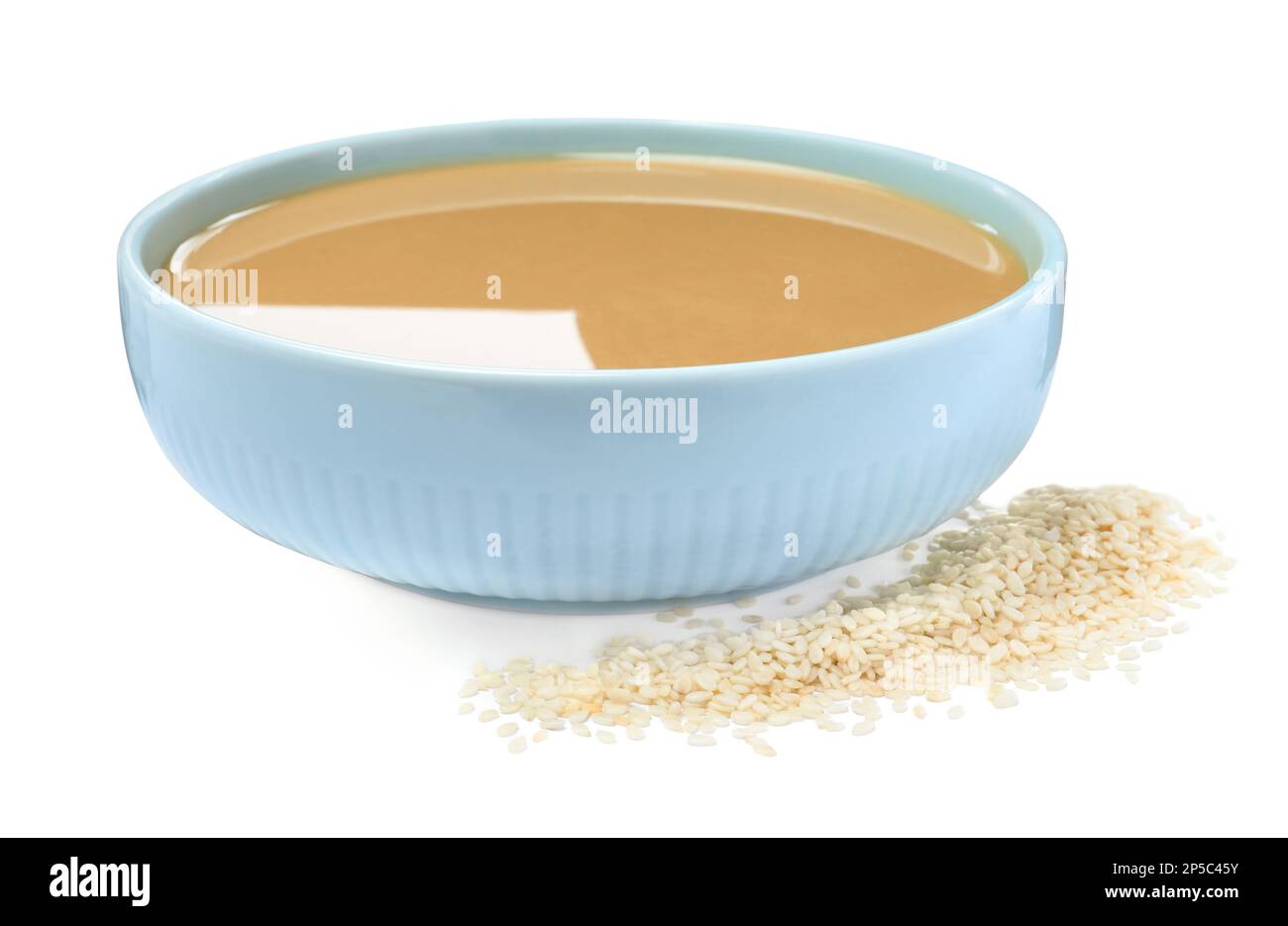 Tasty sesame paste in bowl and seeds on white background Stock Photo ...