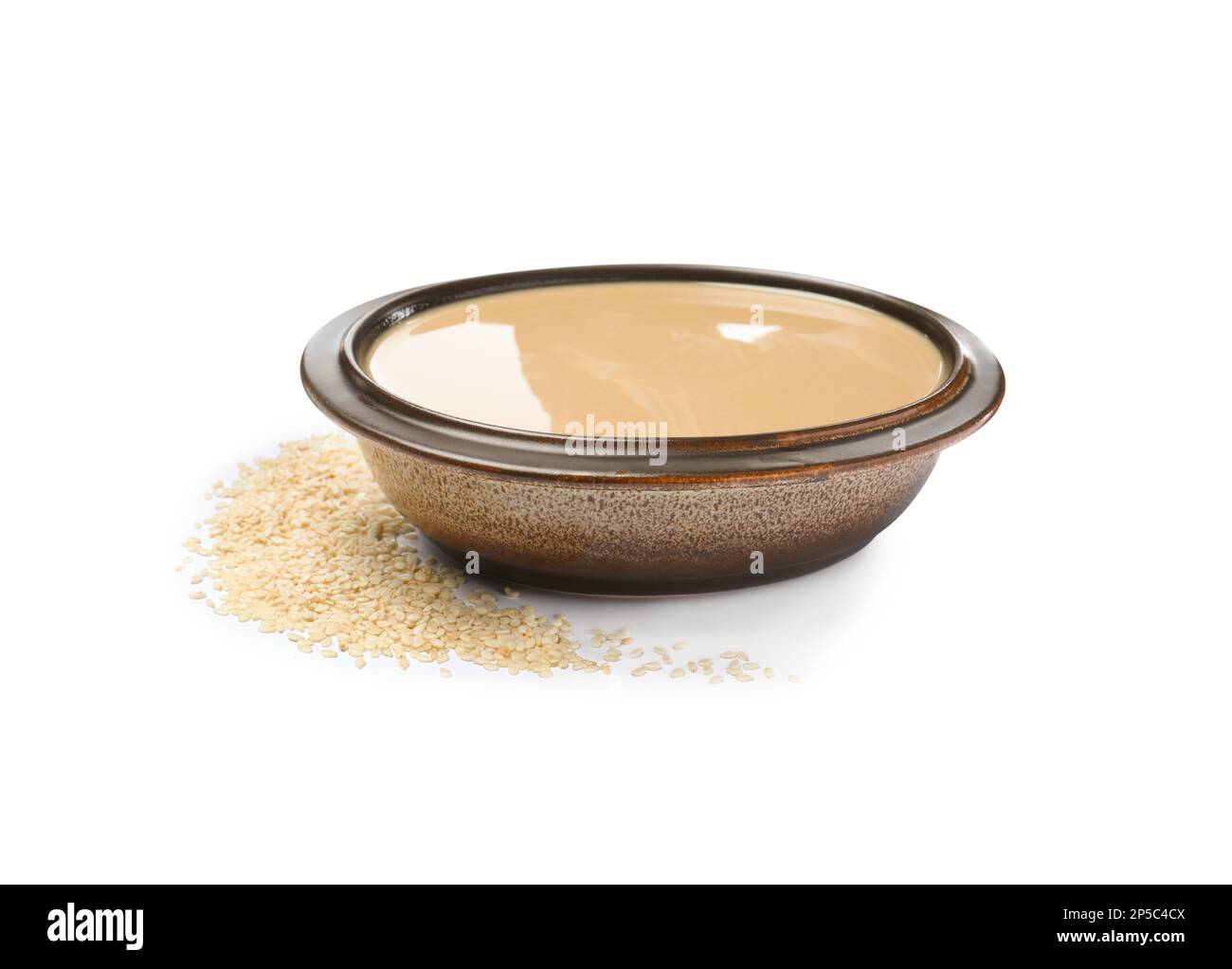 Tasty sesame paste in bowl and seeds on white background Stock Photo ...