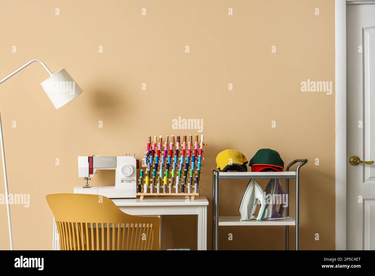 Interior of modern atelier with tailor's workplace and shelving unit ...