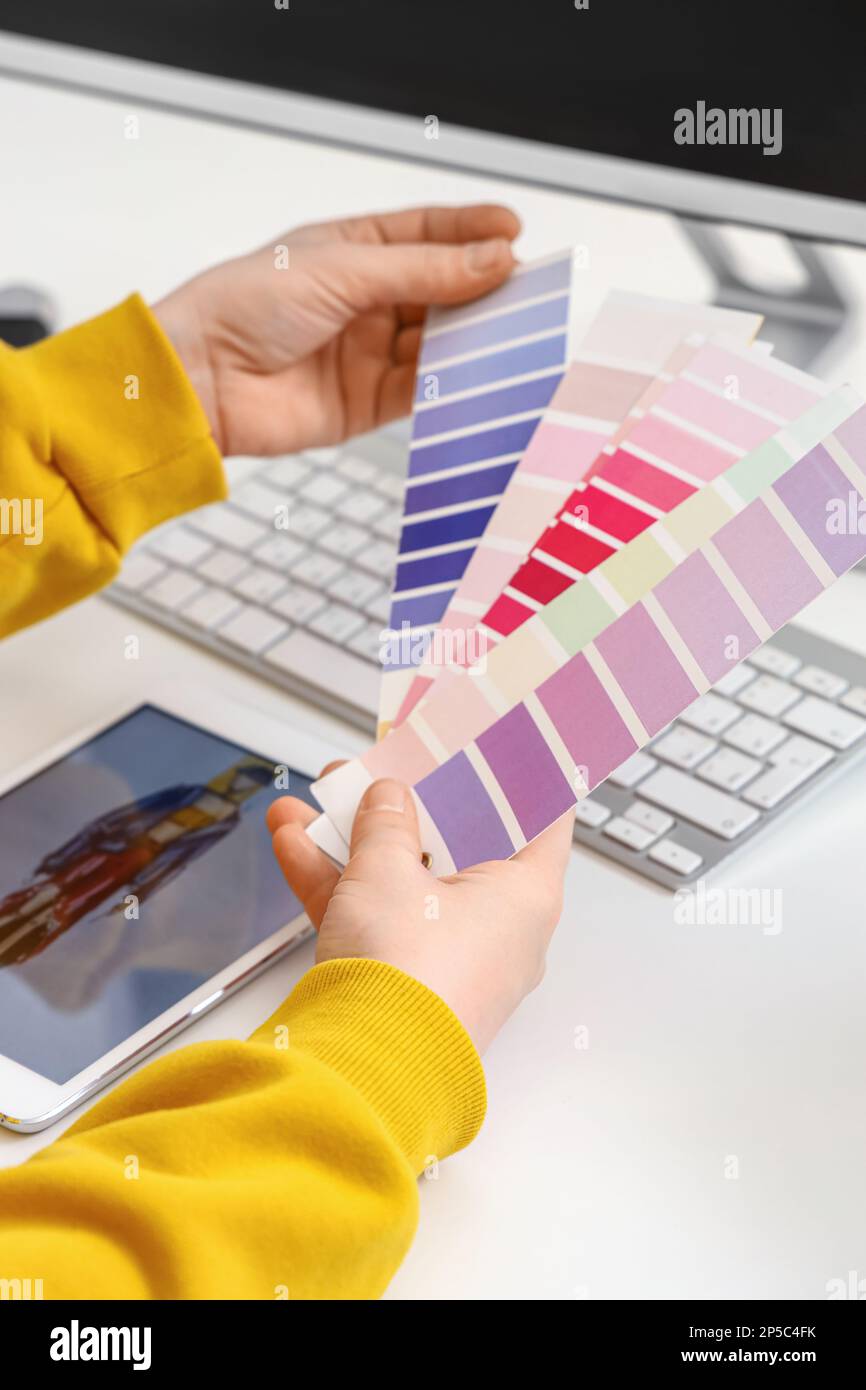 Female tailor with color palettes at table, closeup Stock Photo - Alamy