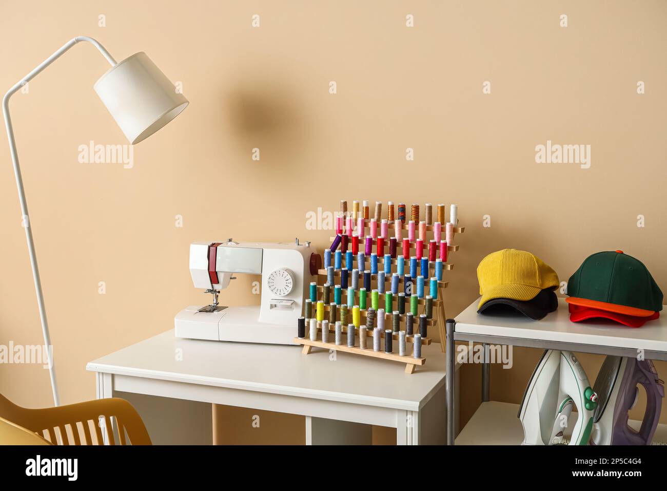 Interior of modern atelier with tailor's workplace and shelving unit ...