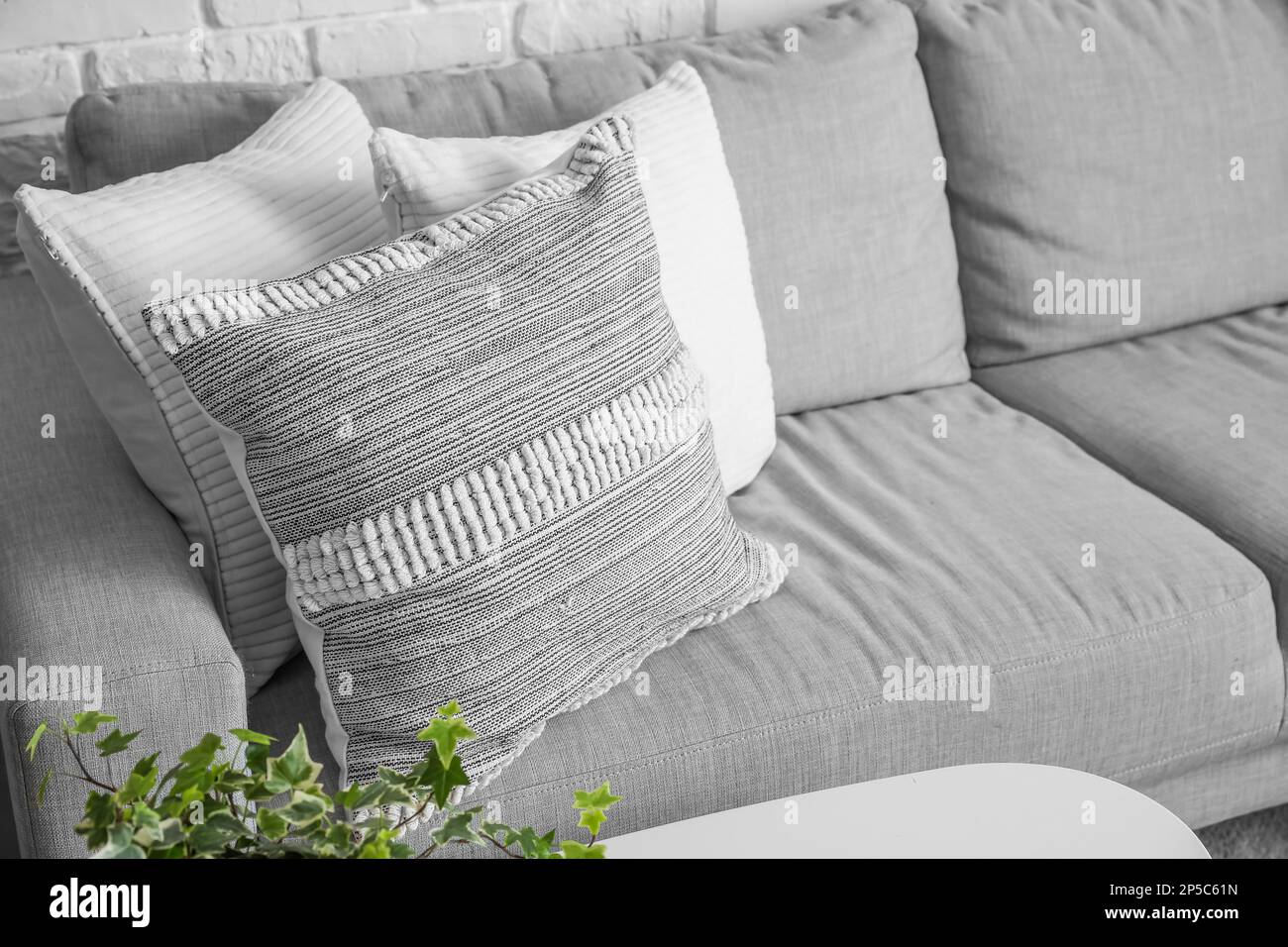 Soft cushions om cozy grey sofa, closeup Stock Photo - Alamy
