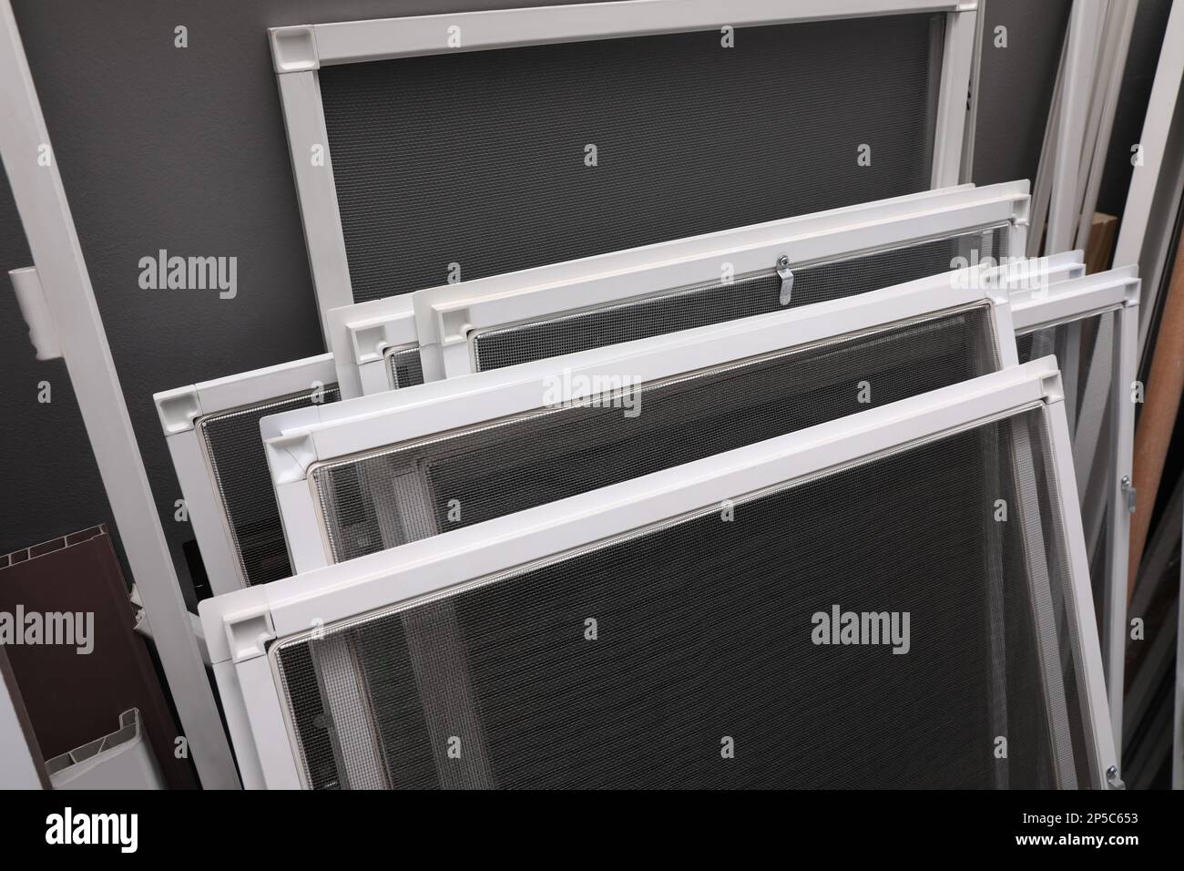 Mosquito window screens near grey wall, closeup Stock Photo - Alamy