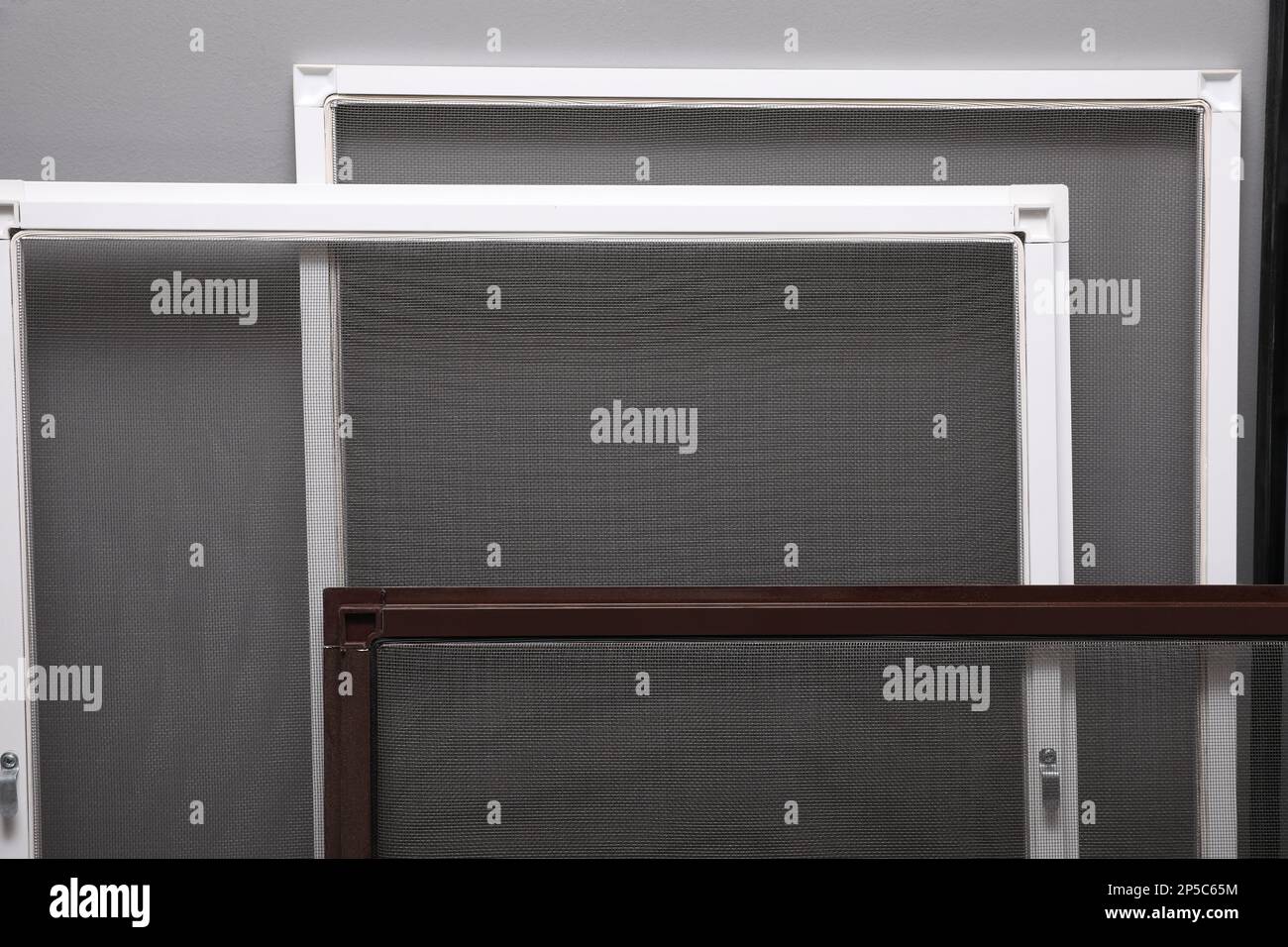 Mosquito window screens near grey wall, closeup Stock Photo - Alamy