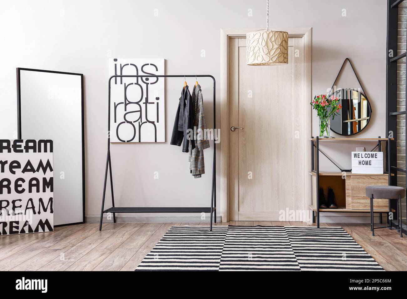Interior of modern hall with rack, mirrors and door Stock Photo - Alamy